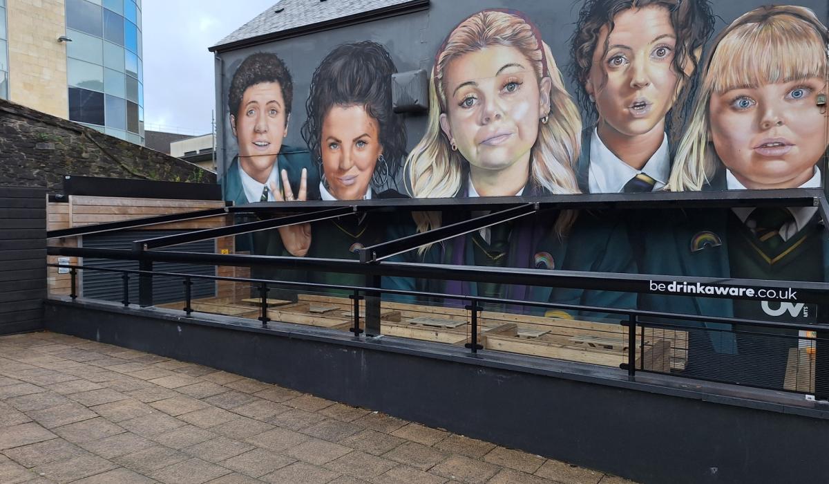 Controversial awning blocking Derry Girls mural reinstalled days after ...